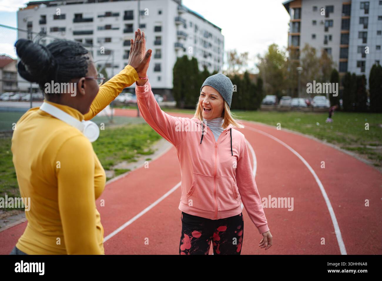 Women friends high-fiving celebrating workout accomplishment Stock ...