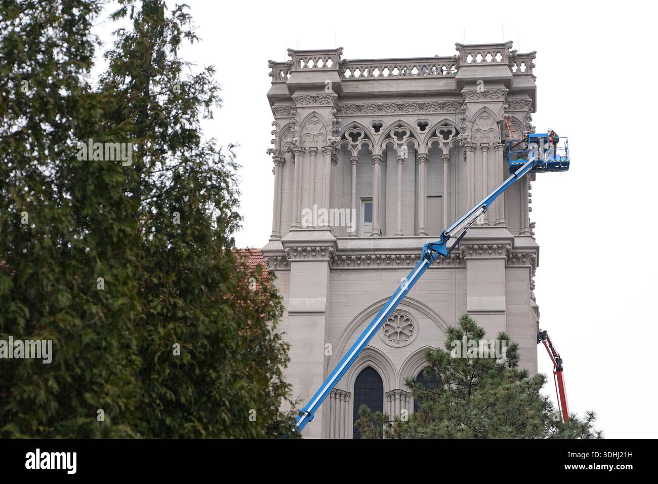 Workers install gargoyles on the Cathedral Basilica of the Assumption ...