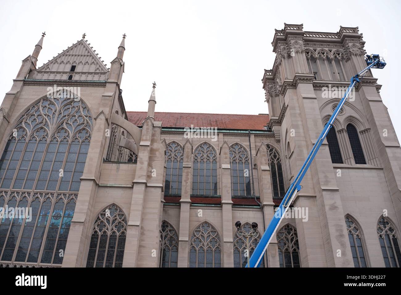 Workers install gargoyles on the Cathedral Basilica of the Assumption ...