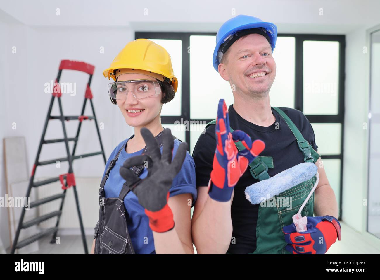 Happy construction workers showing teamwork spirit in a bright ...
