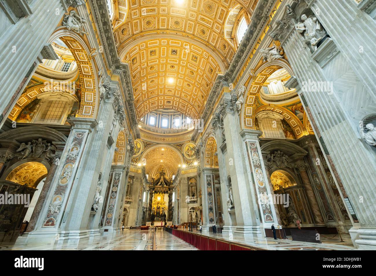 St. Peter's basilica interior featuring ornate gold relief, columns ...