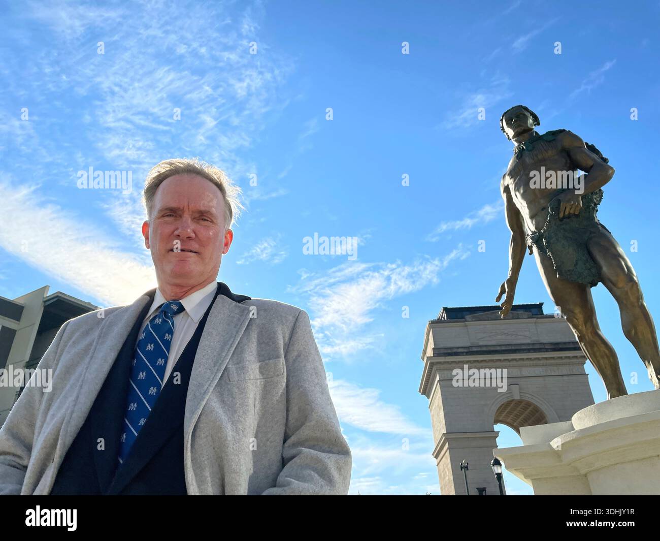 FILE - Developer Rodney Mims Cook Jr. stands next to the statue of ...