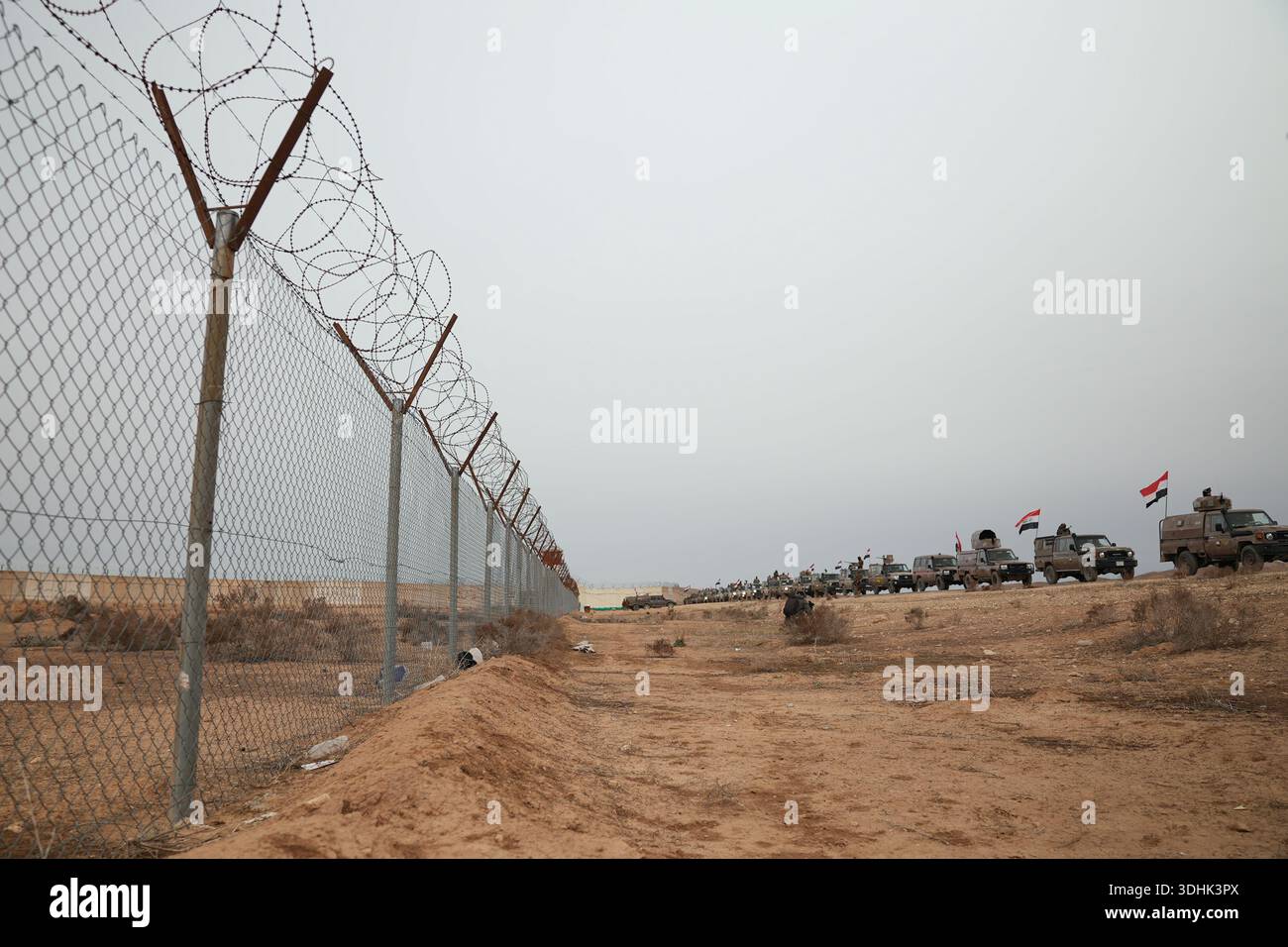 Iraqi Border Guards patrol in armored vehicles along the border with ...