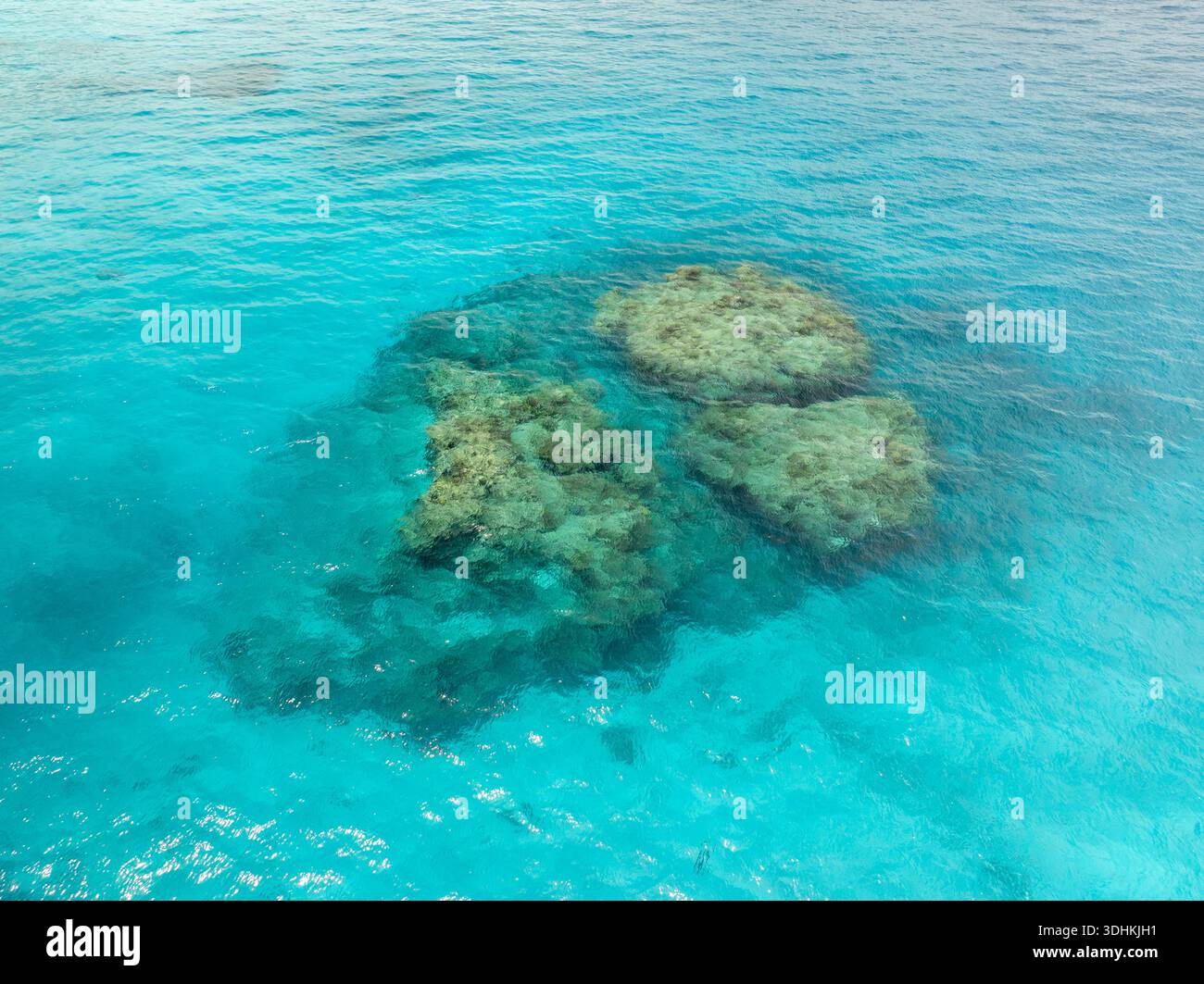 Aerial view of the turquoise waters surrounding the coral reefs ...