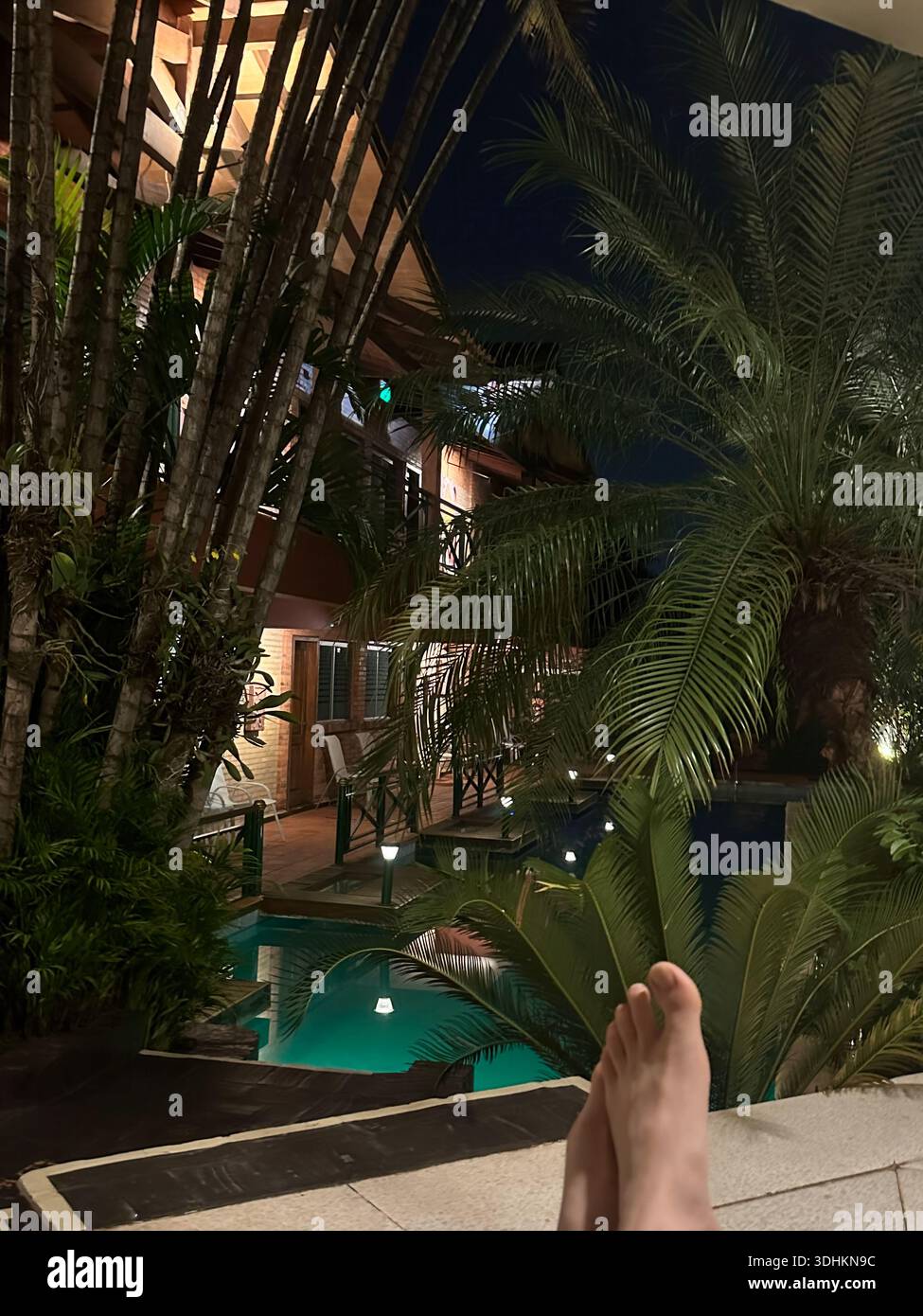 Point of view of legs on a bed with towel looking through a large ...