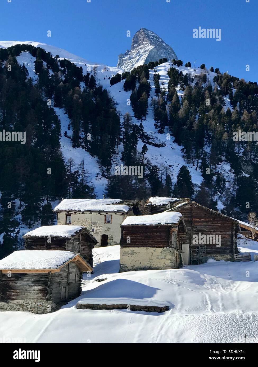 Winter scene in the Swiss Alps, Zermatt, featuring traditional wooden ...