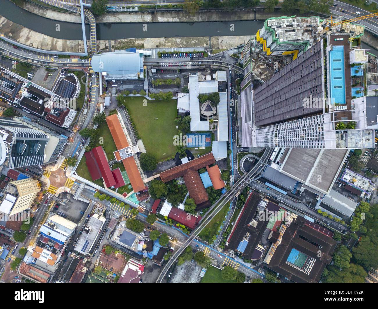 Aerial view of a modern city blending old red-roofed buildings with ...