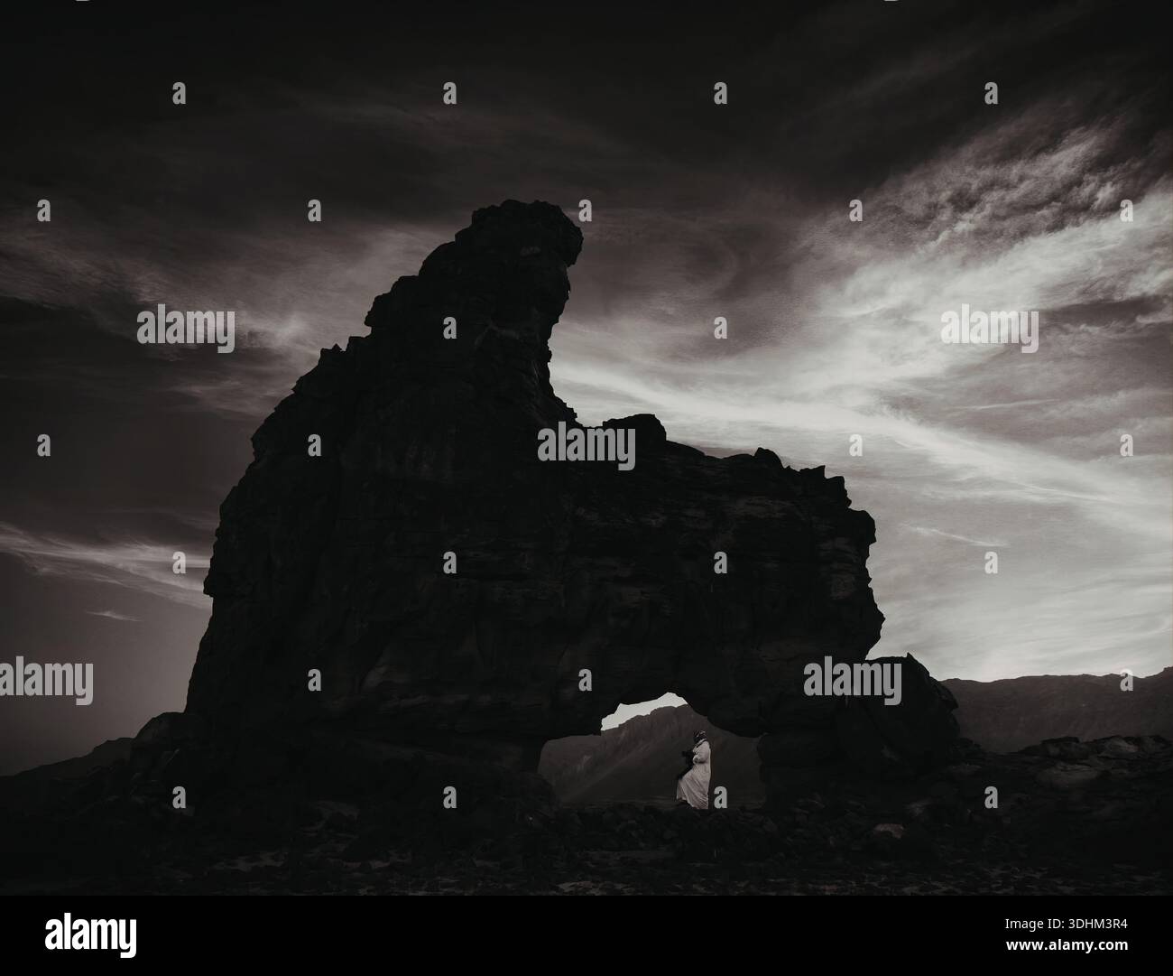 A striking black and white photograph featuring a prominent rock ...