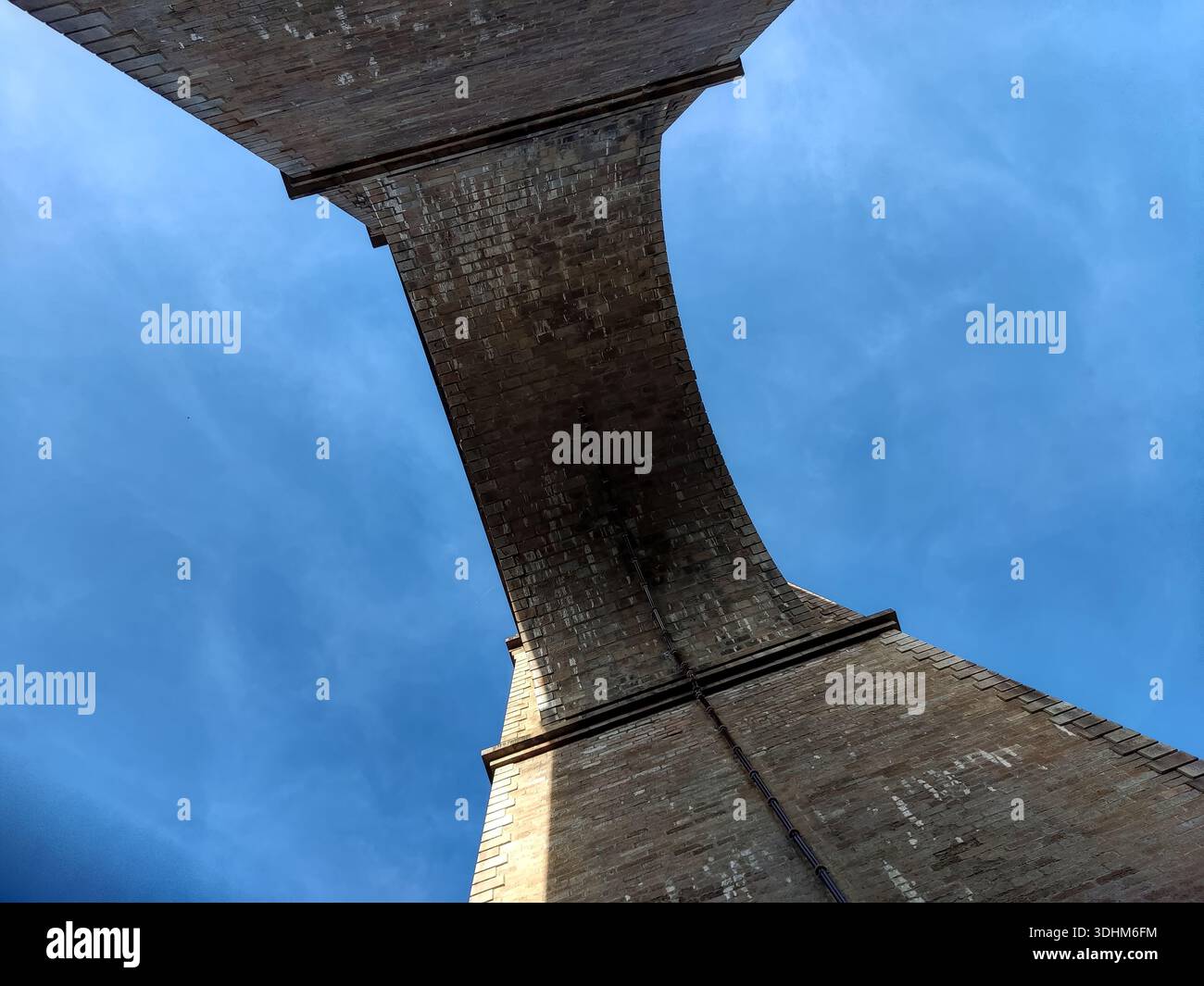 Monumental stone bridge captured from an unusual angle, emphasizing its ...