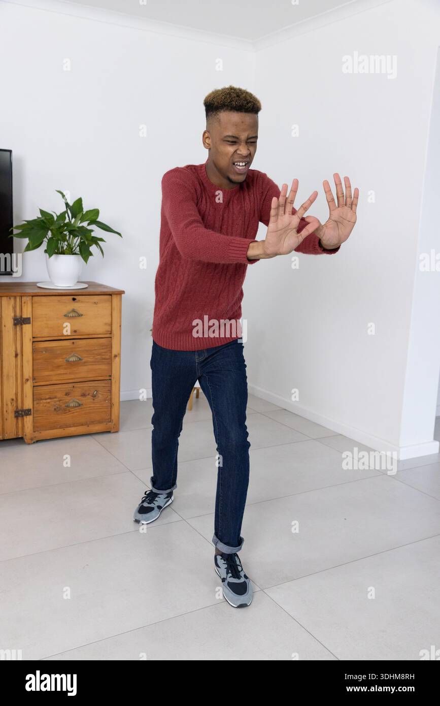 Man raising hands squinting hi-res stock photography and images - Alamy