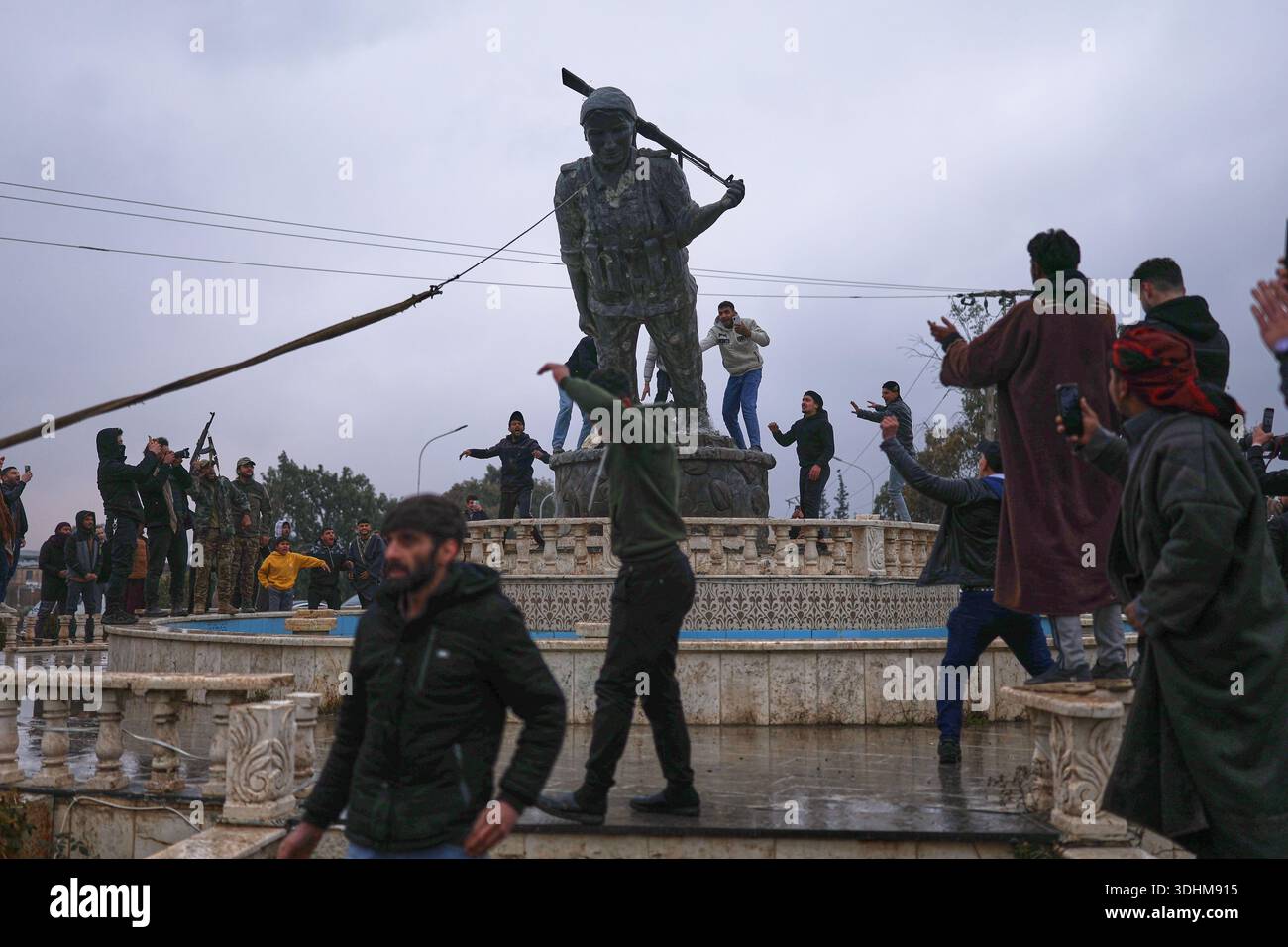 FILE - Residents topple a statue of a female Kurdish fighter after the ...