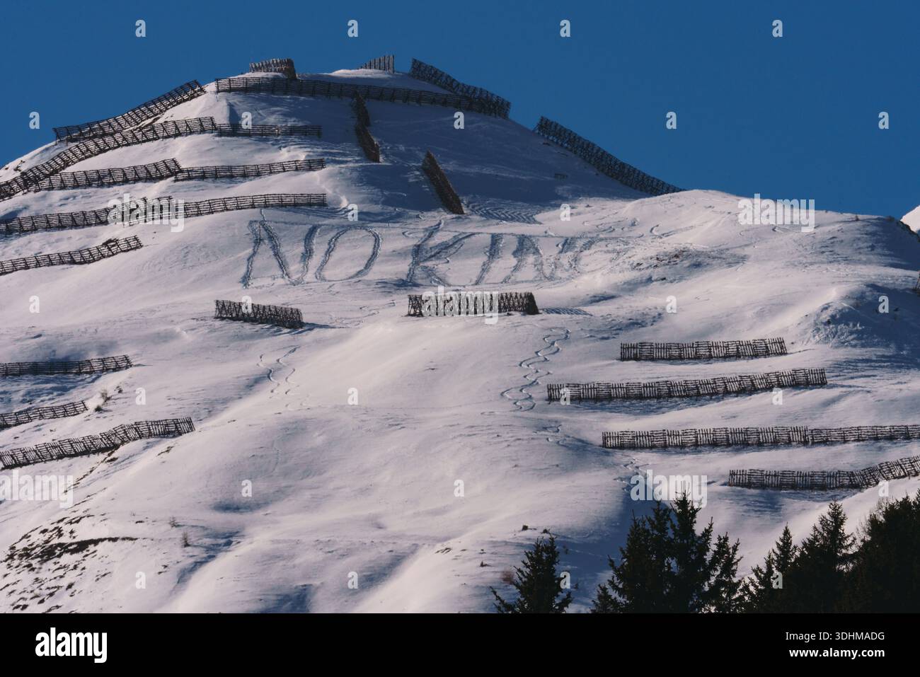 No king message written in snow on a mountain with avalanche barriers ...