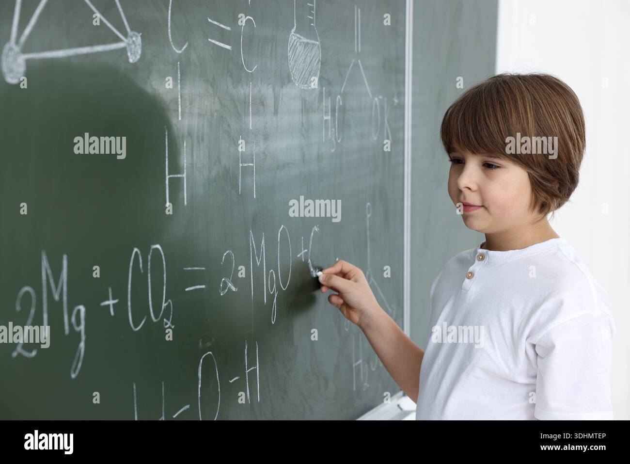 Schoolboy writing chemical formula hi-res stock photography and images ...
