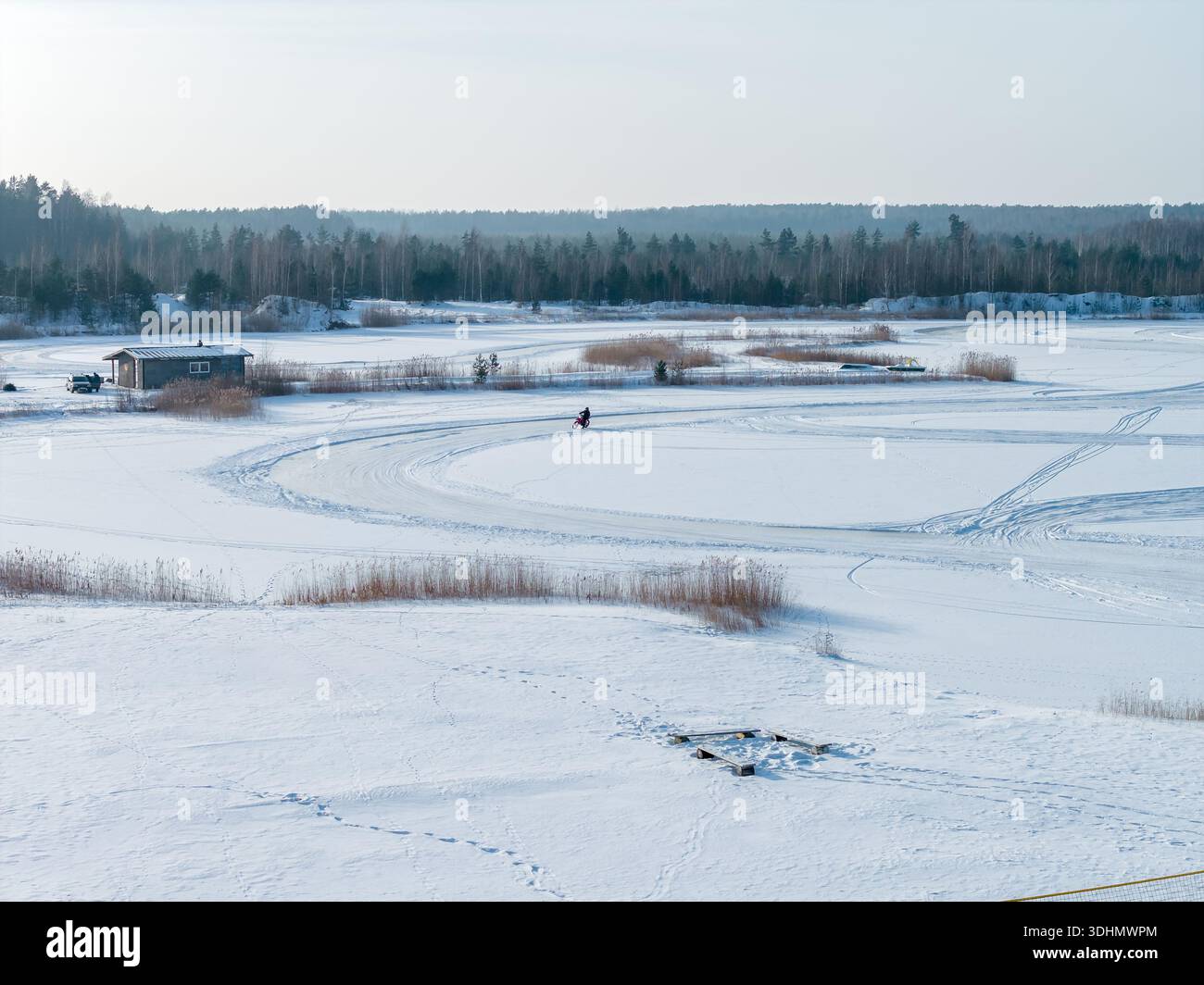 Aerial frozen lake oval ice racetrack with motorcyclist and cabin Stock ...