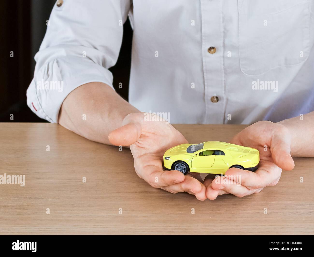 Male hand holding toy hi-res stock photography and images - Alamy
