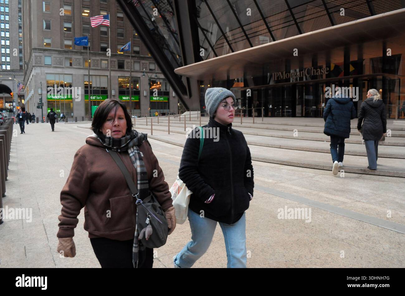 People walk outside of the JPMorgan Chase global headquarters building ...