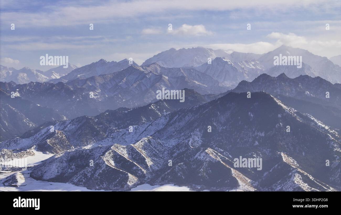 The Qilian Mountains are covered with snow after a snowfall in Minle ...
