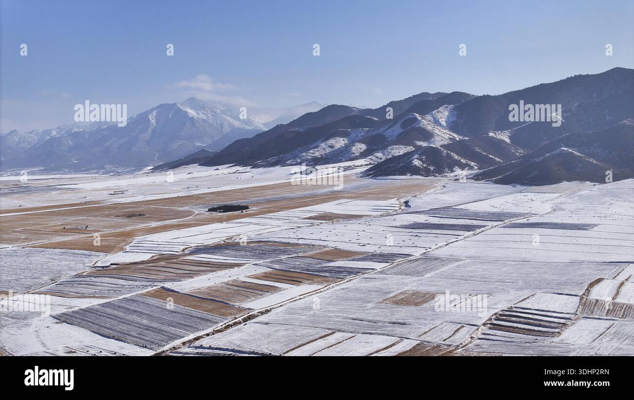 The Qilian Mountains are covered with snow after a snowfall in Minle ...