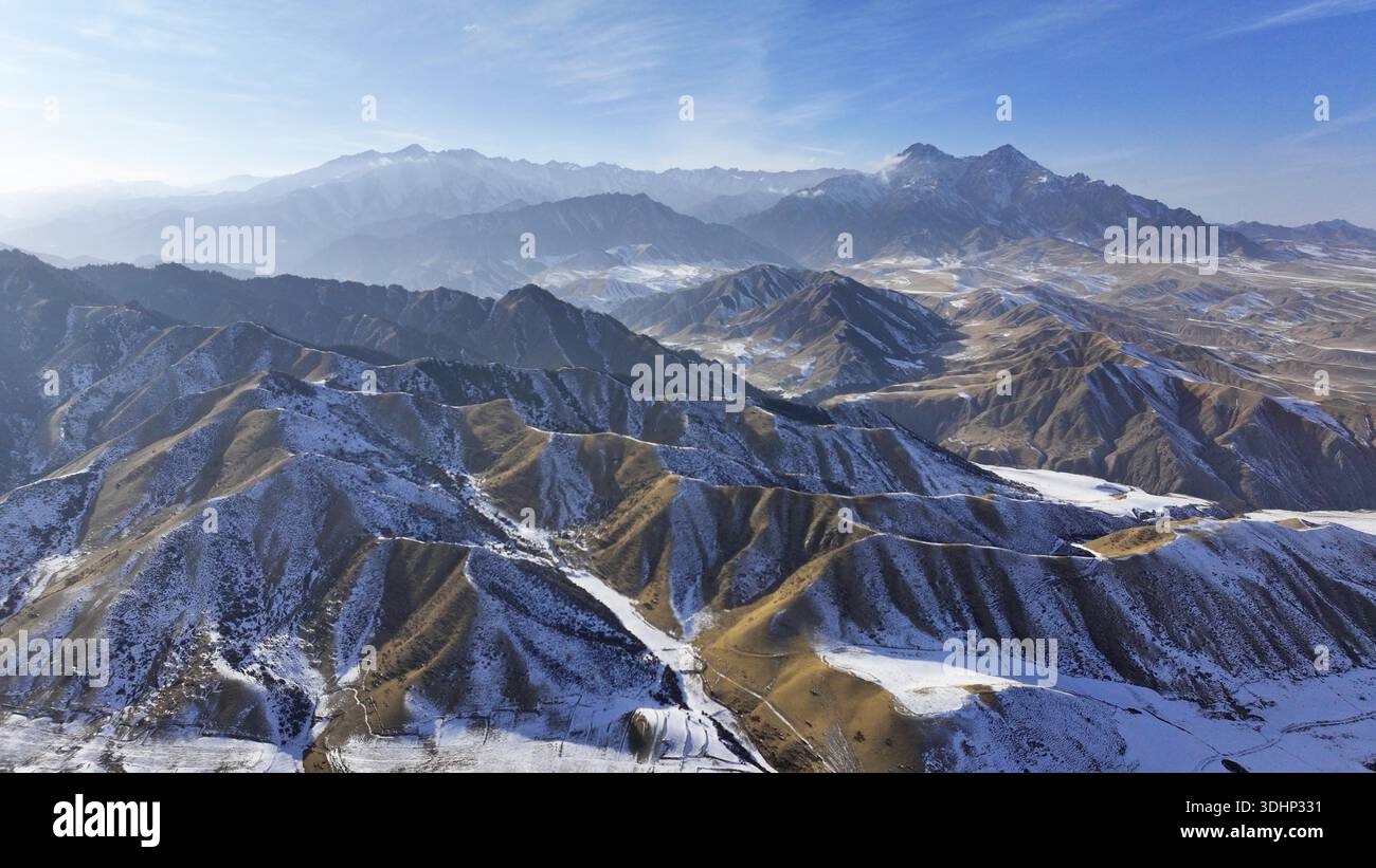 The Qilian Mountains are covered with snow after a snowfall in Minle ...