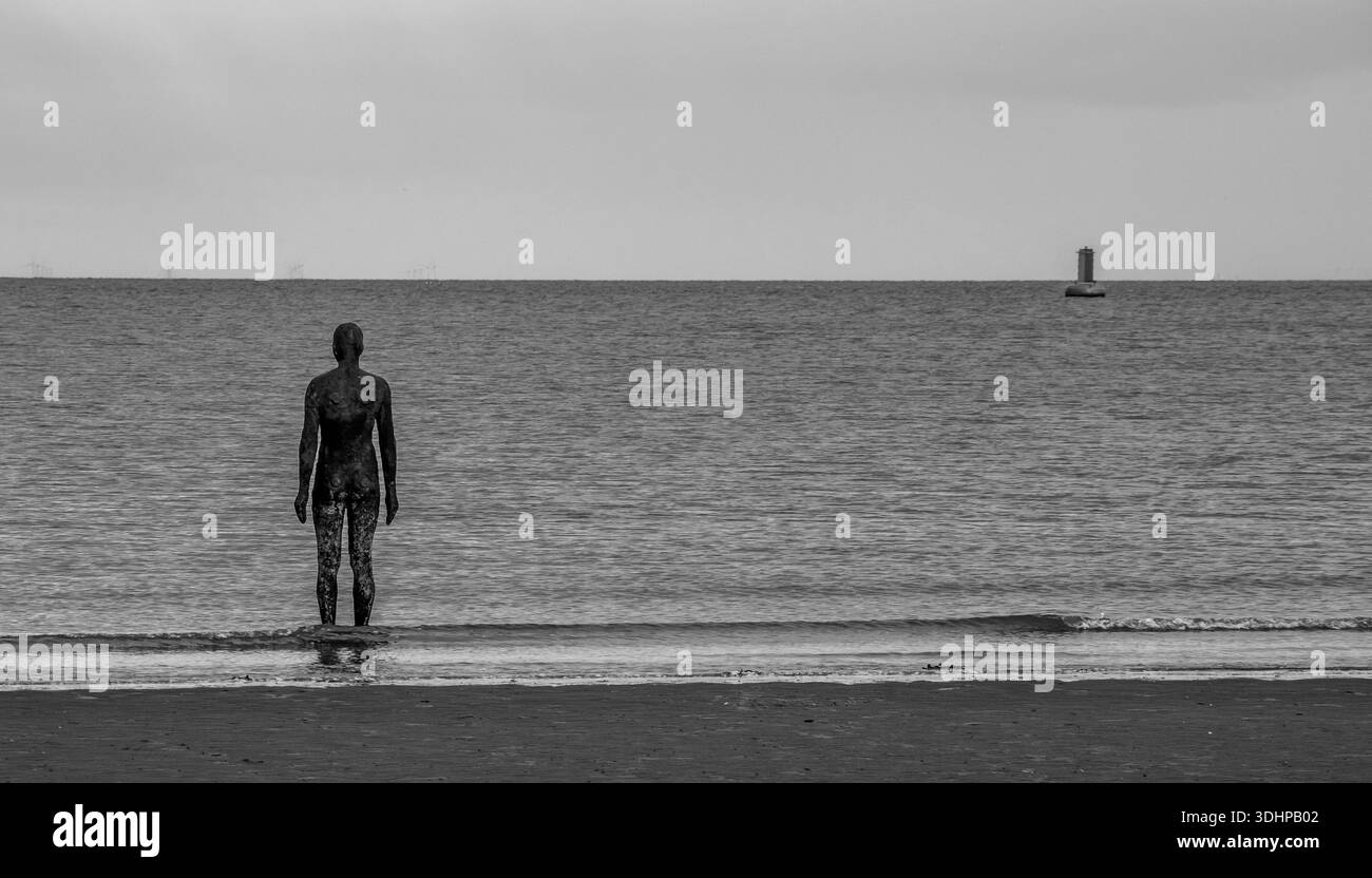 Figure from Antony Gormley’s Another Place installation standing in the ...
