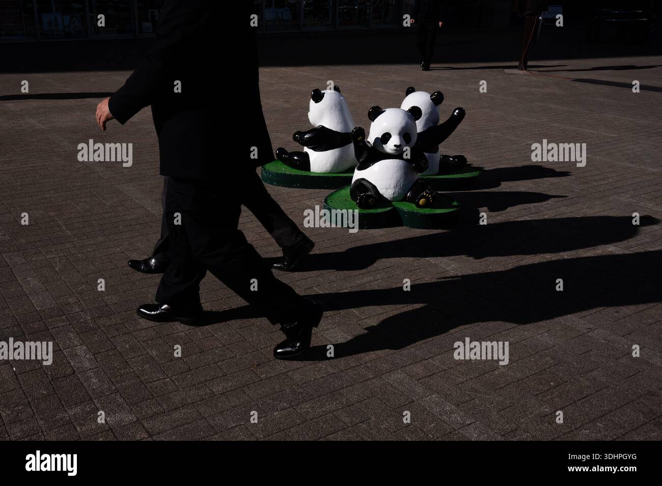 Pedestrians pass panda statues in a square near Ueno Zoo in Tokyo ...