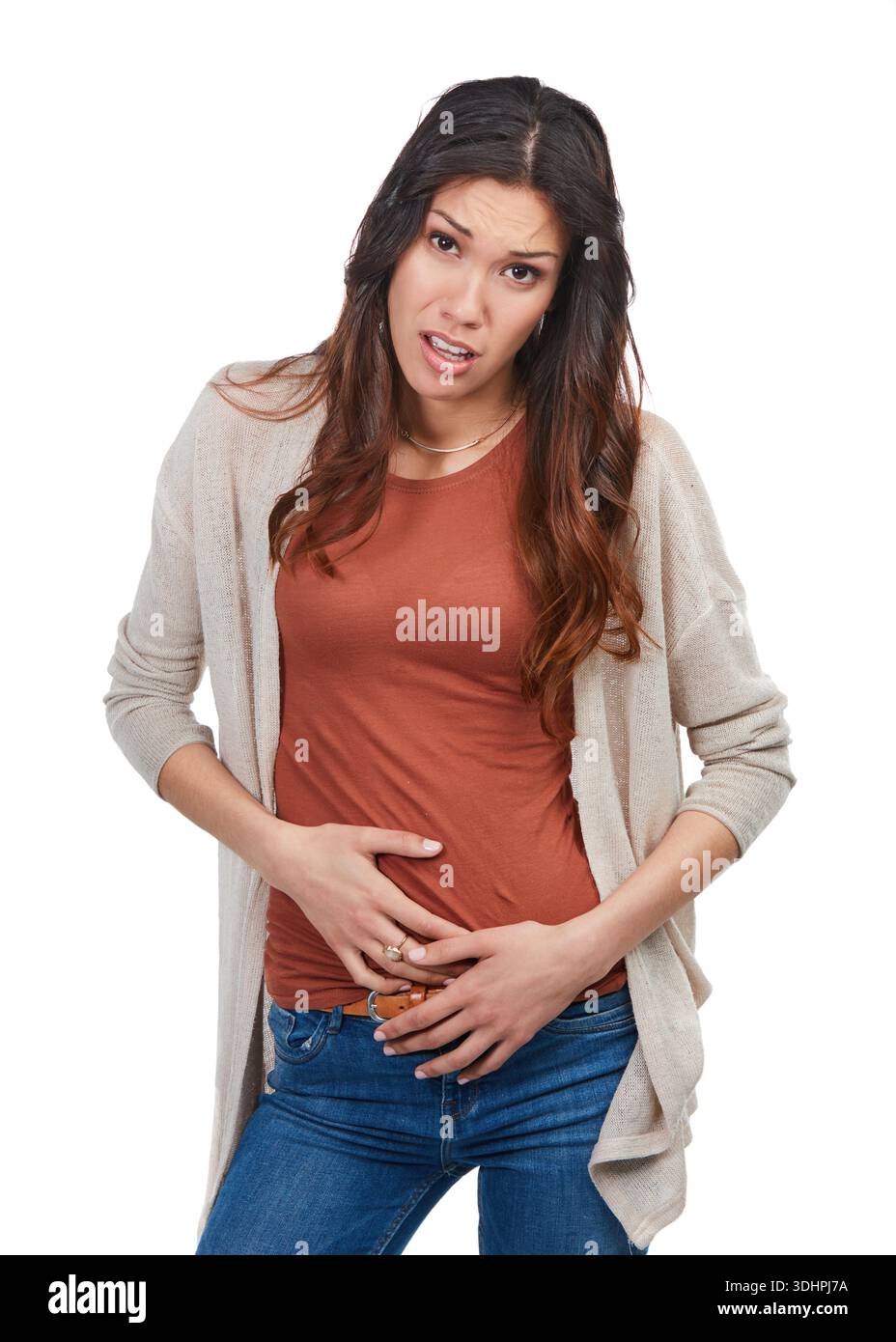 Portrait, woman and unhappy in studio with stomach ache from ...