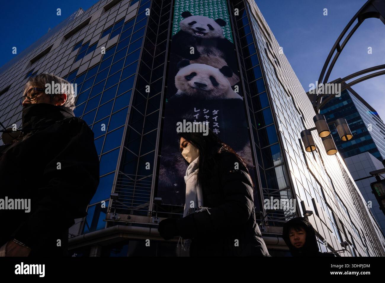Pedestrians walk past a billboard bidding farewell to Japan's last ...