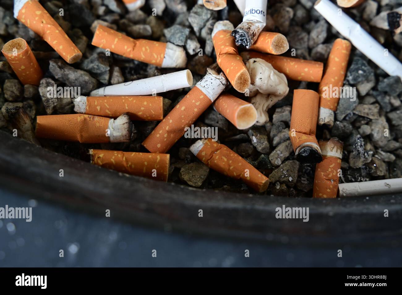 Several cigarettes seen in a concrete ashtray at the Alpe d'Huez ski ...