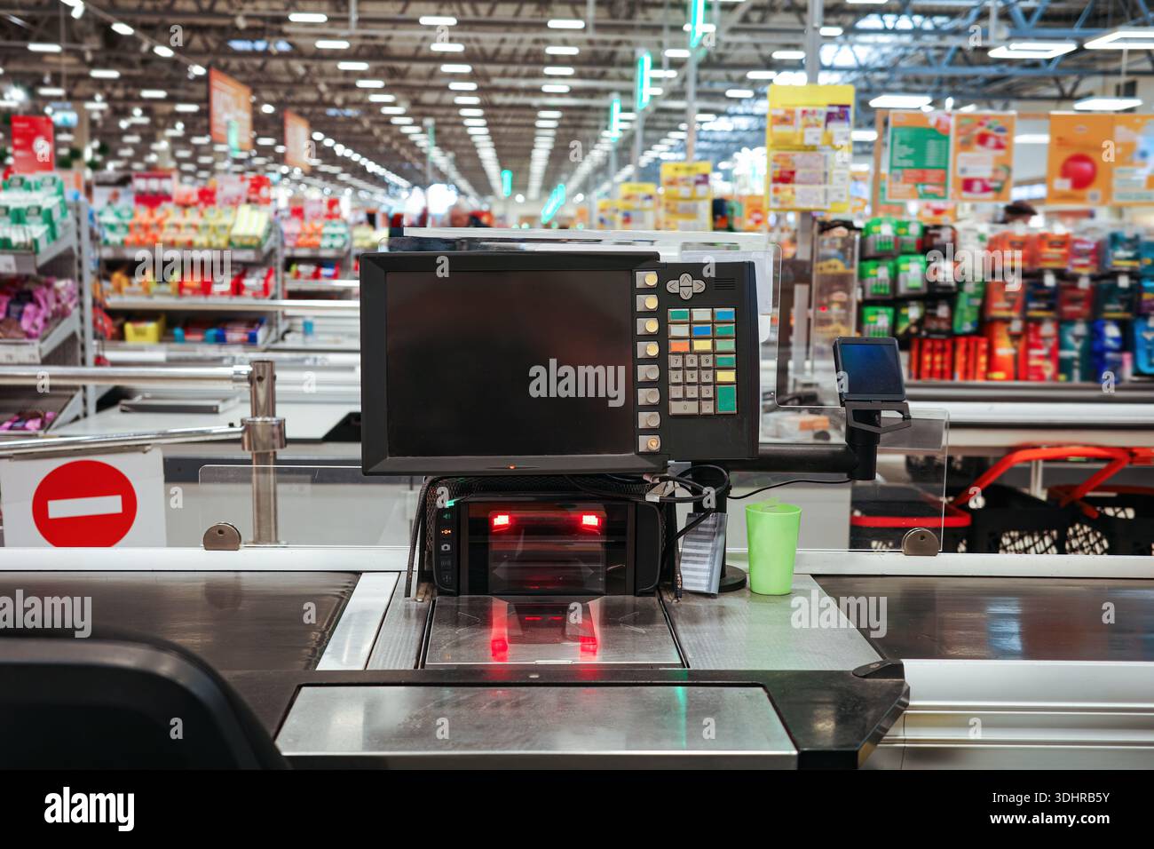 Modern supermarket checkout terminal with screen, barcode scanner, red ...