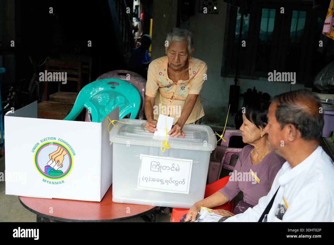 A woman casts her early ballots at their residence in Yangon, Myanmar ...