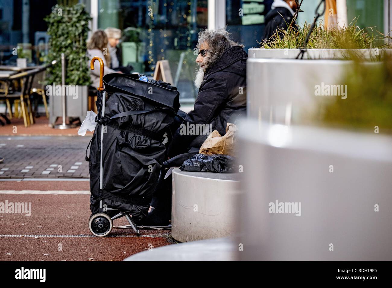 THE HAGUE - A man sits on a bench in the hedge ROBIN UTRECHT/ ANP ...