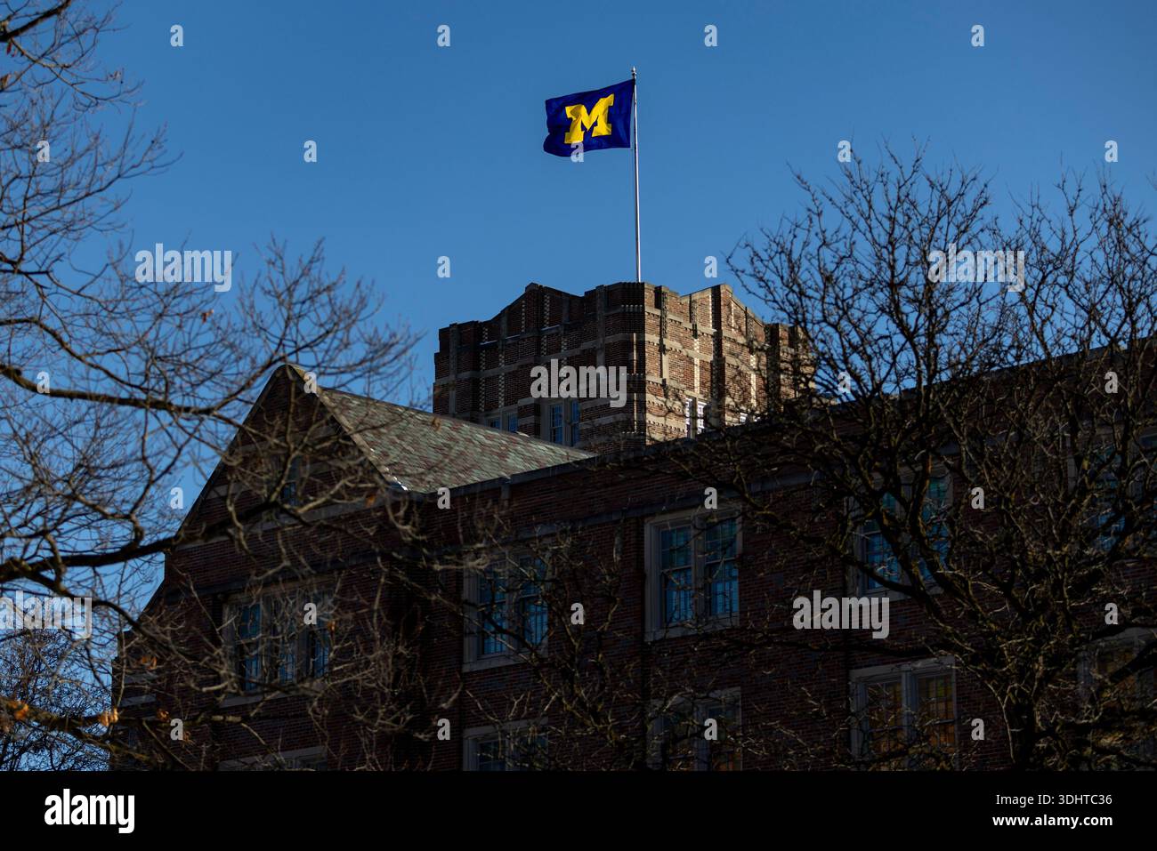 A flag blows in the wind atop the Michigan Union on the University of ...