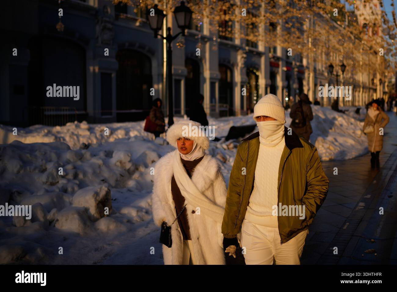 People walk along snow-covered Nikolskaya street in Moscow, Friday, Jan ...
