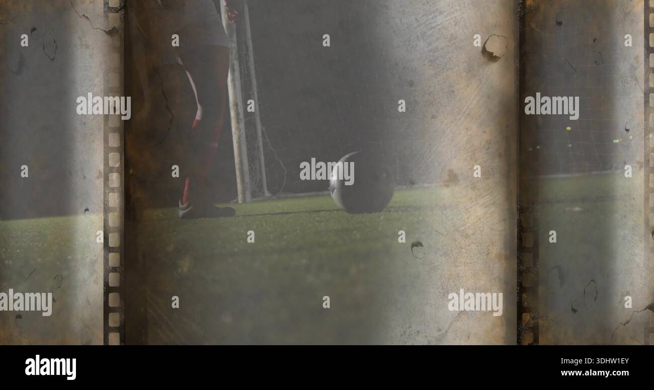 Framing soccer ball on turf pitch, lights shining, player legs wearing ...