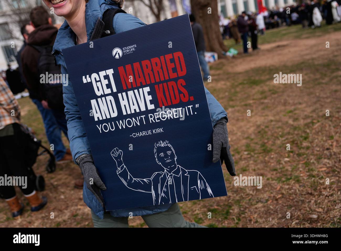 A woman carries a sign with a quote from Charlie Kirk during the annual ...