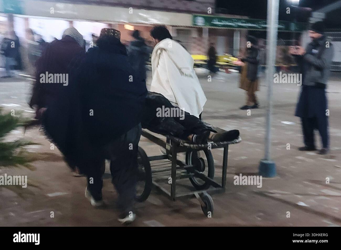 Volunteers transport an injured victim of suicide bombing at a wedding ...