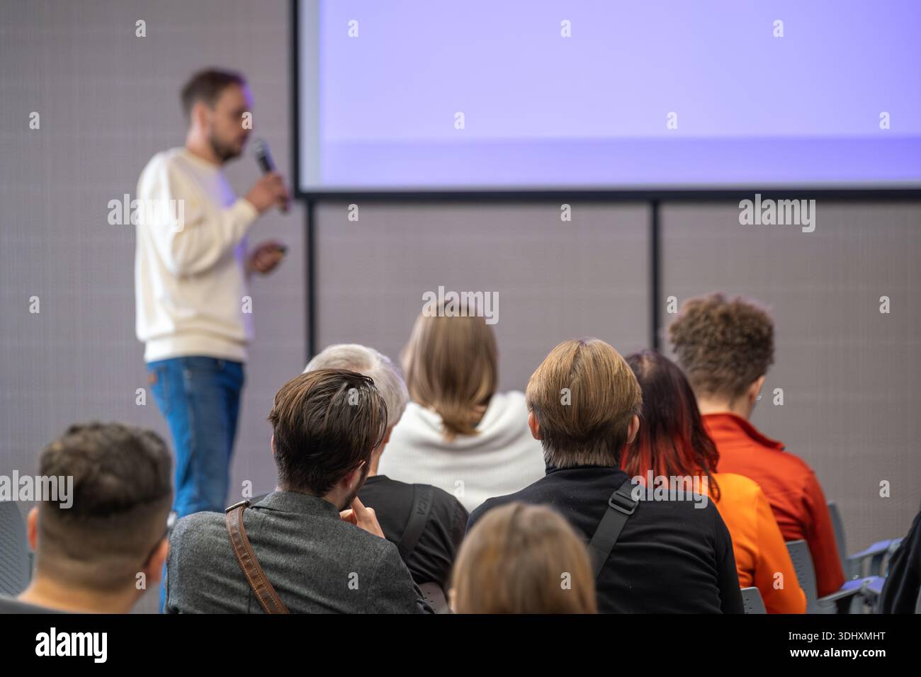 Presenter speaks seated audience hi-res stock photography and images ...