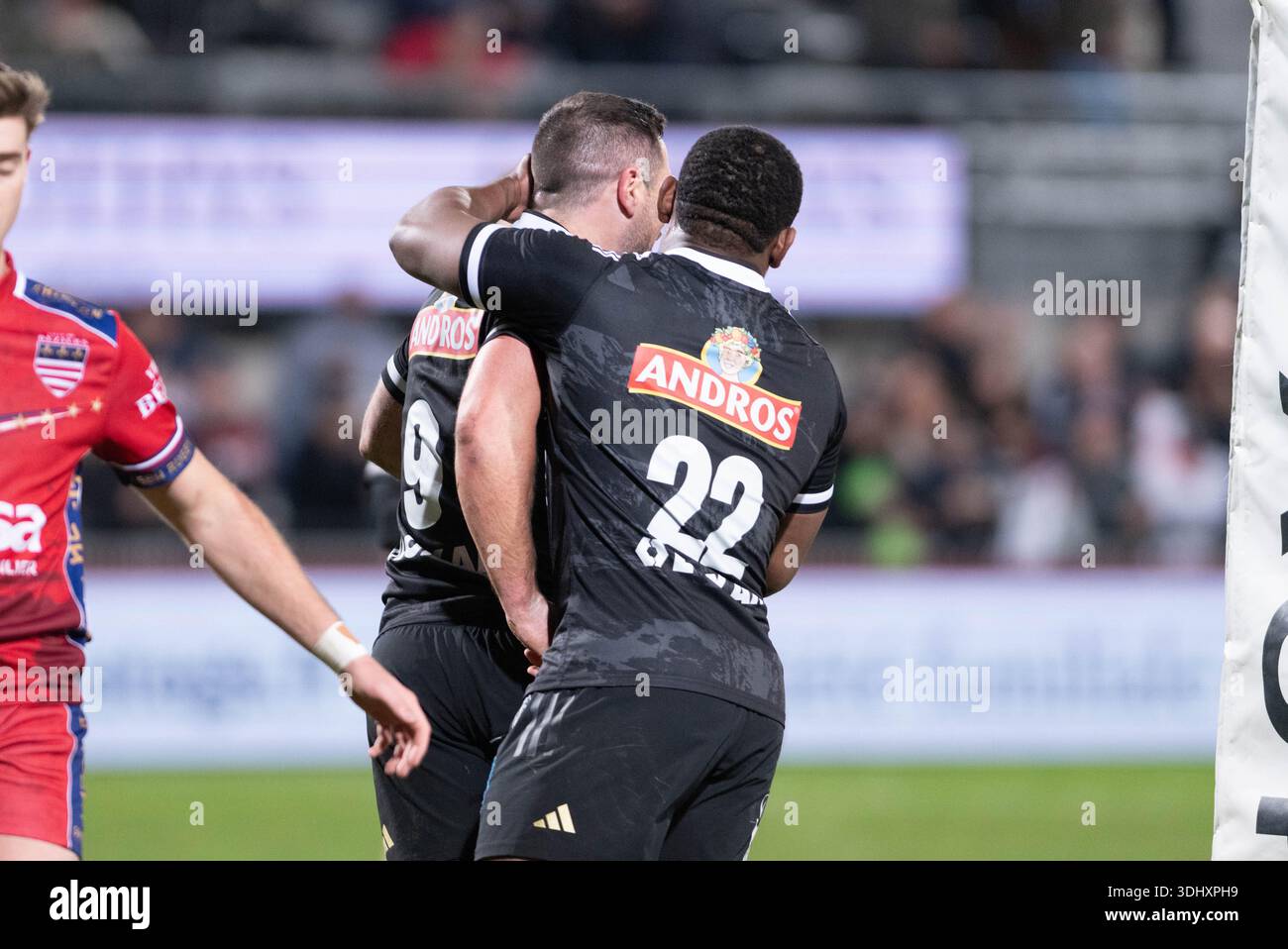 John Cooney of Brive celebrates his try with team mates during the Pro ...