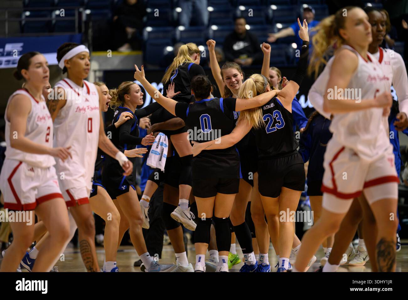 BYU players celebrate beating ranked Texas Tech during an NCAA college ...