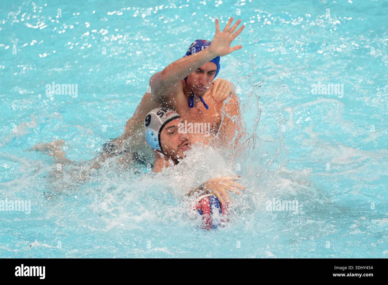Serbia's Nemanja Vico, front, challenges for the ball with Italy's ...