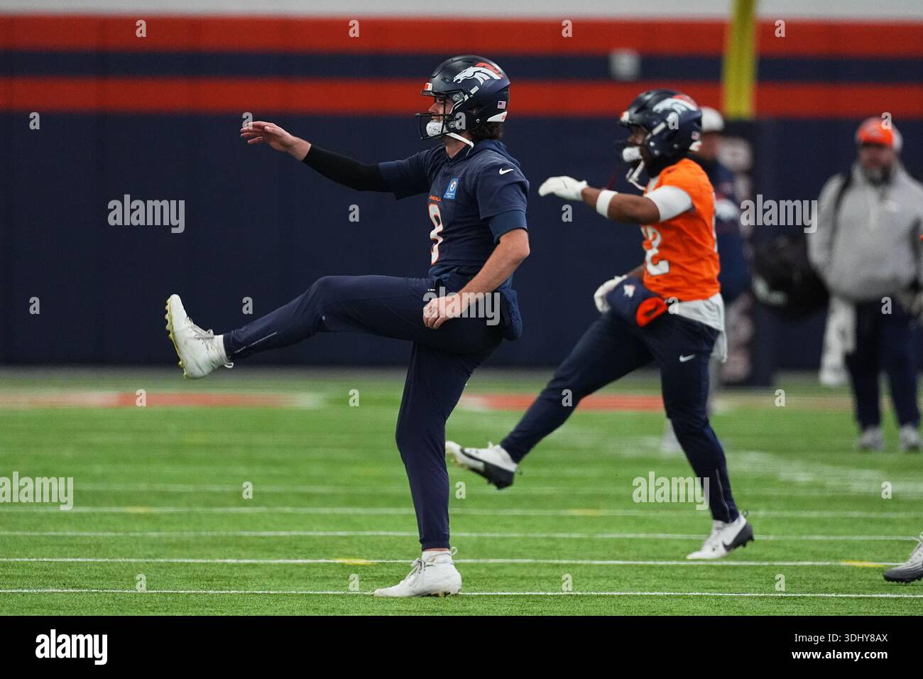Denver Broncos quarterback Jarrett Stidham, left, warms up before ...