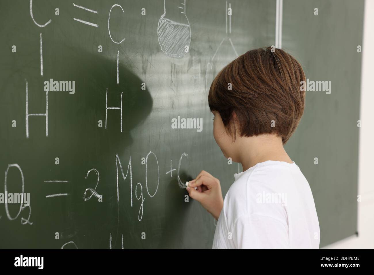 Schoolboy writing chemical formula hi-res stock photography and images ...