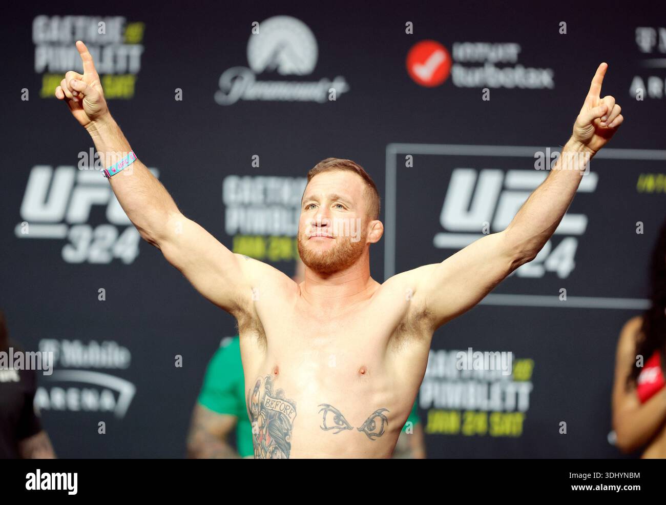 UFC lightweight fighter Justin Gaethje poses on the scale during a ...