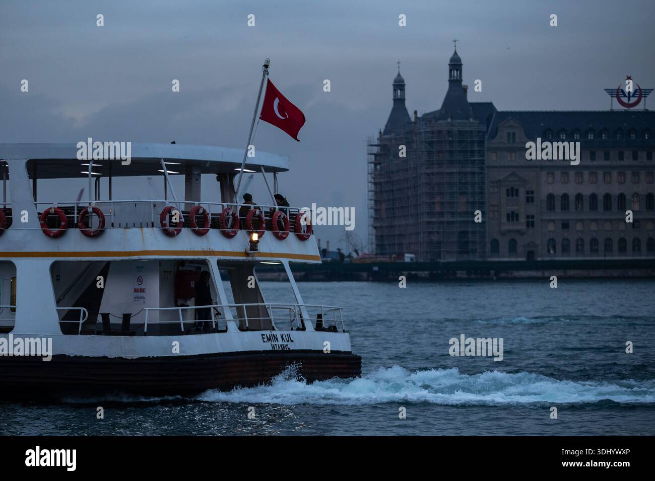 A city ferry Is seen with Haydarpasa Train Station in the background ...