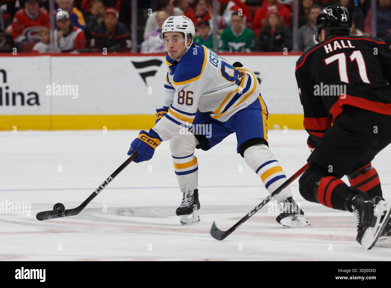 Buffalo Sabres' Noah Ostlund (86) is challenged by Carolina Hurricanes ...