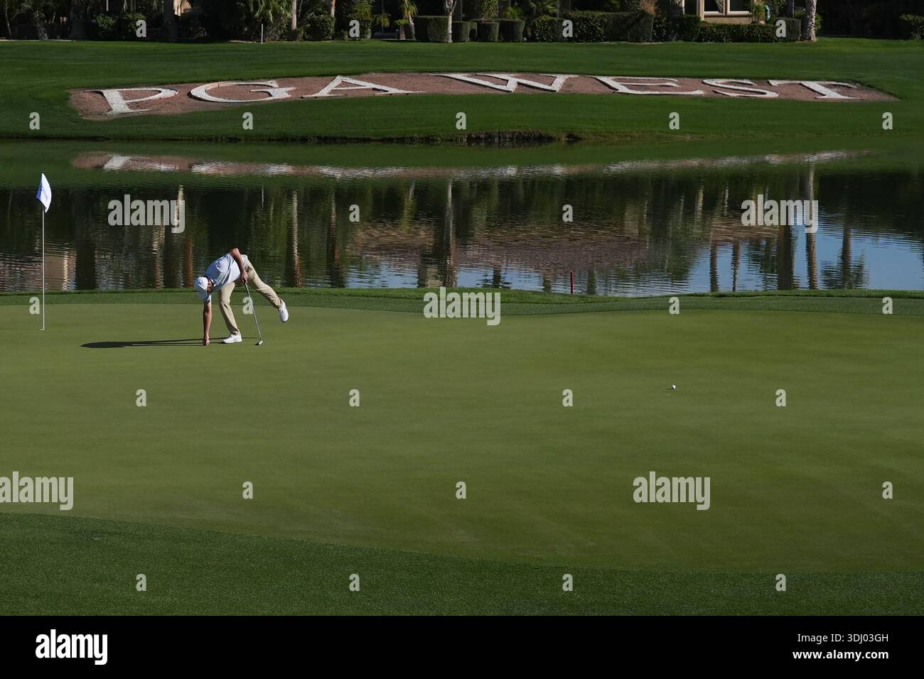 Scottie Scheffler fixes a ball mark at the ninth green during the ...
