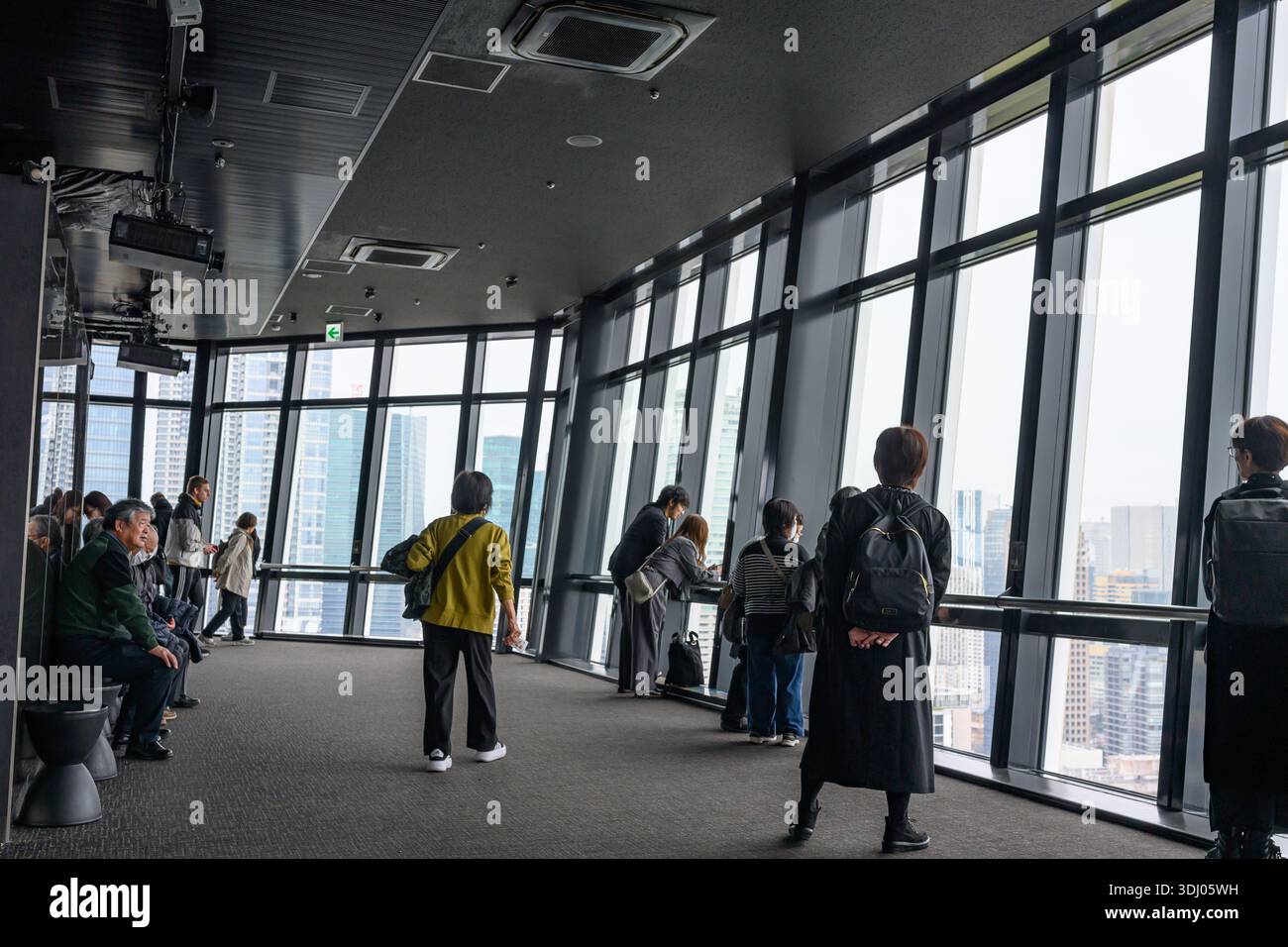 Tourists inside the Tokyo Tower main deck observation viewing area ...