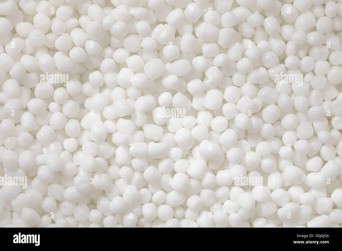 A top-down macro photo shows a dense, uniform collection of polymer ...