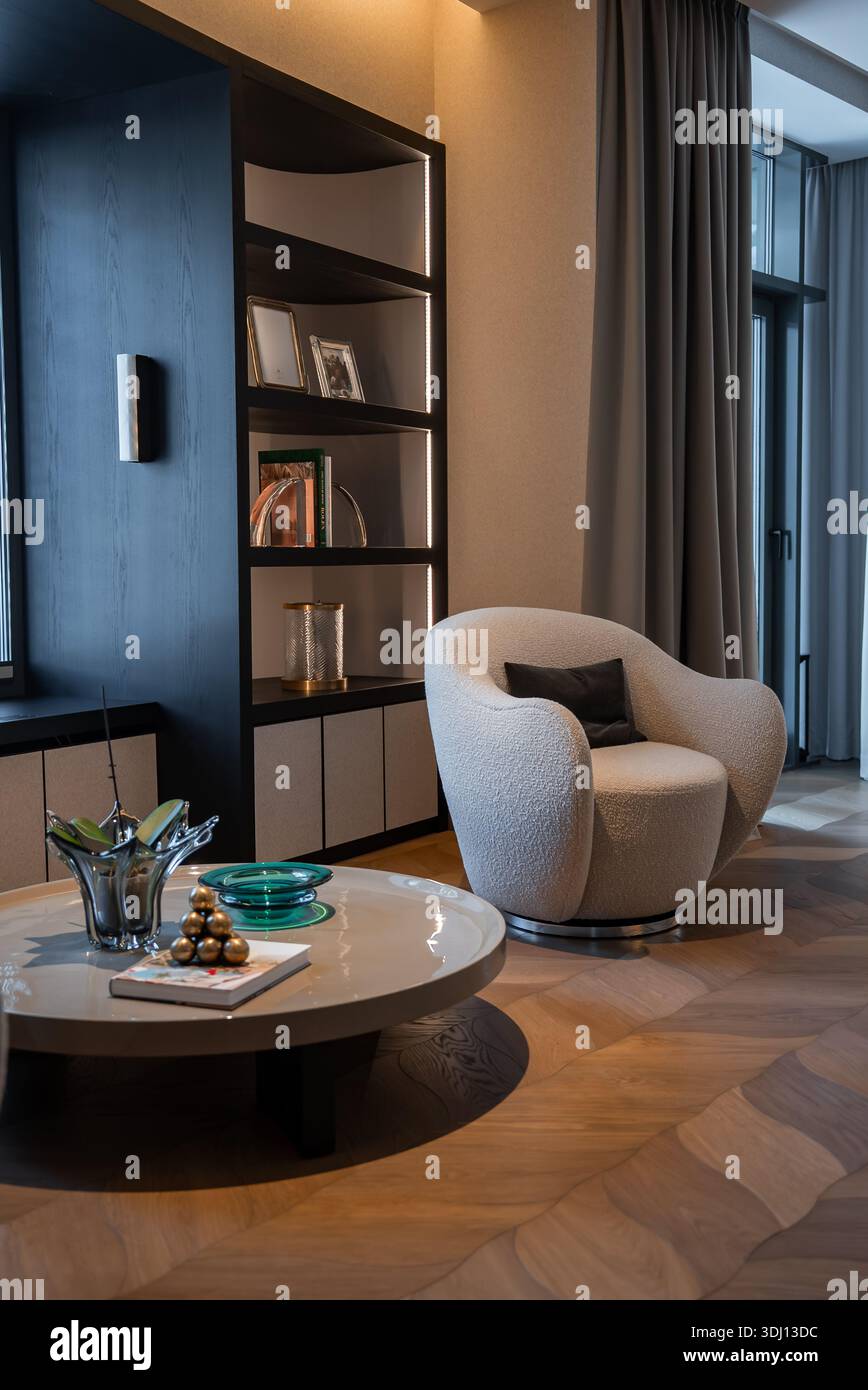 Modern living room corner with boucle swivel chair and shelving unit ...