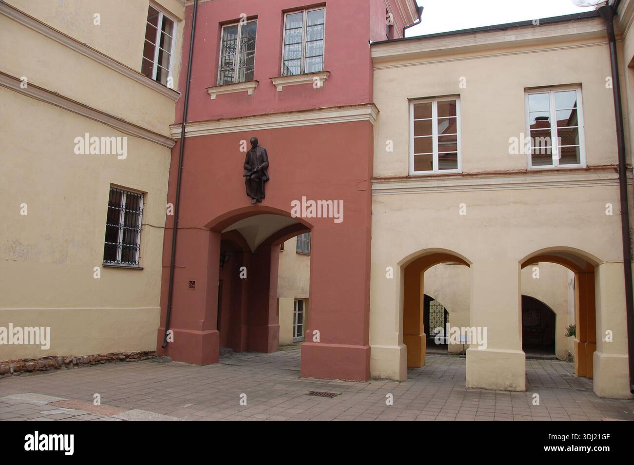 Courtyard of Vilnius University with historic pastel buildings, arched ...